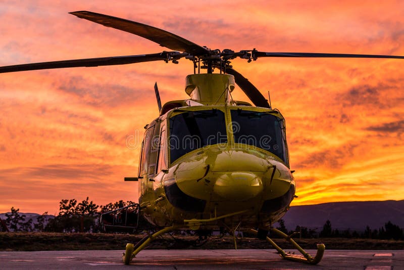 Helicopter on a sunset stock image. Image of helipad - 98794283