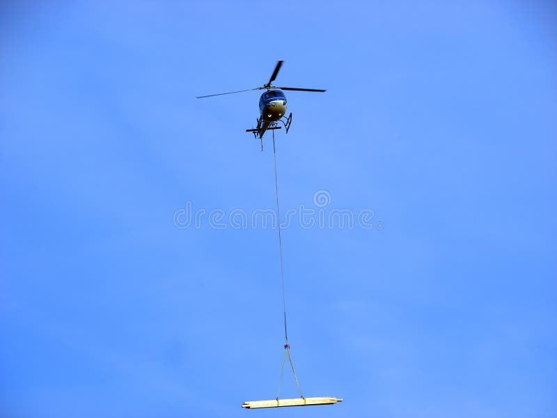 Helicopter transport logs stock image. Image of landing - 112807297