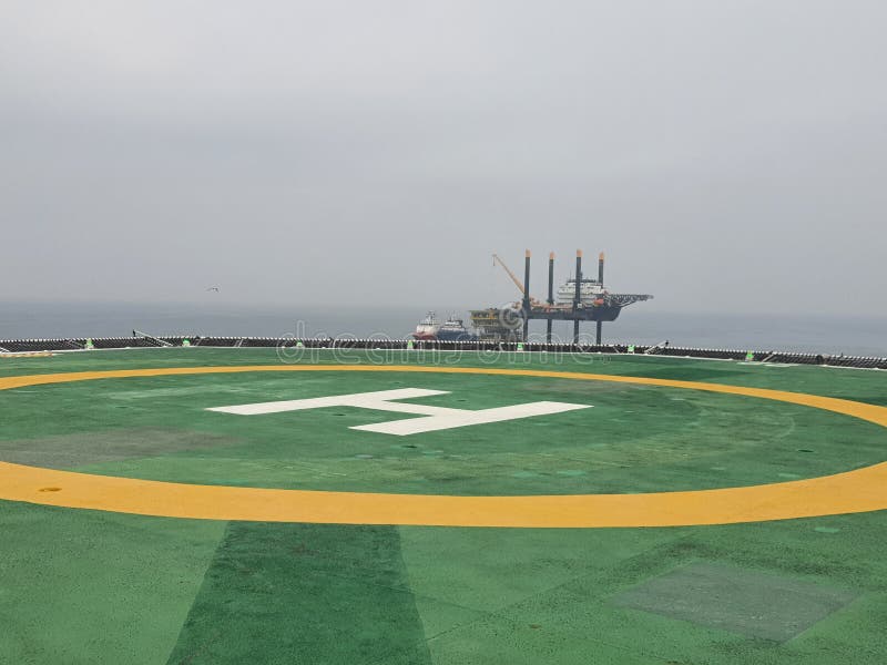 Helideck with Background View of Rig, Platform, and 2 Vessel in the ...