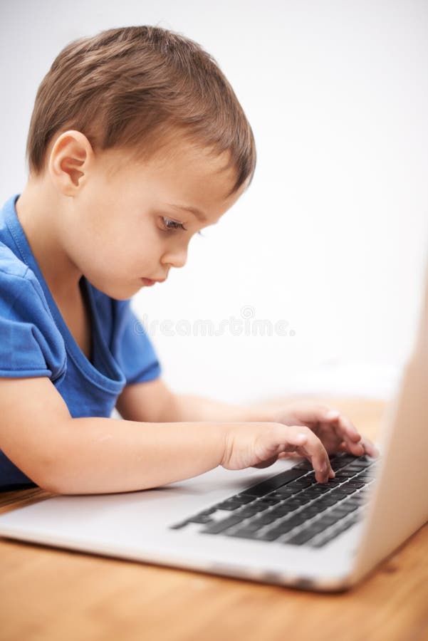 Hell Be a Typist by Age 10. a Young Boy Typing on a Laptop. Stock Image ...