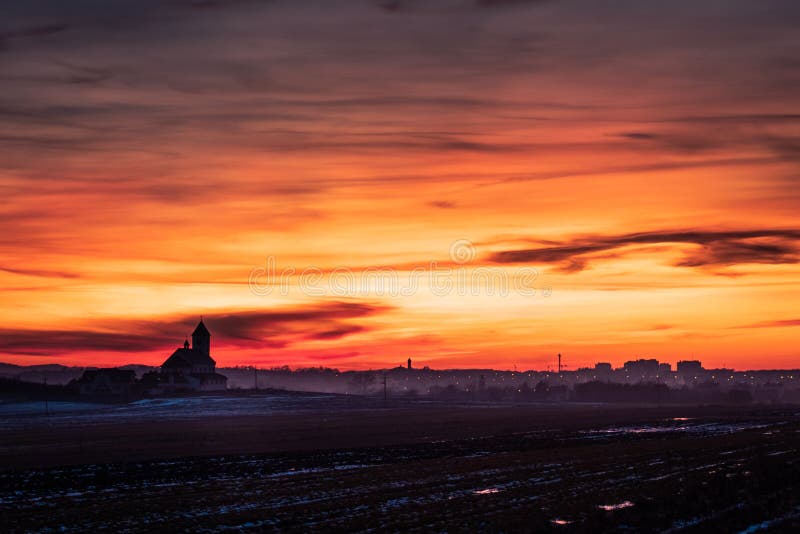 Hellish Sunset - Church and City Aganist Warm Clouds Stock Image ...