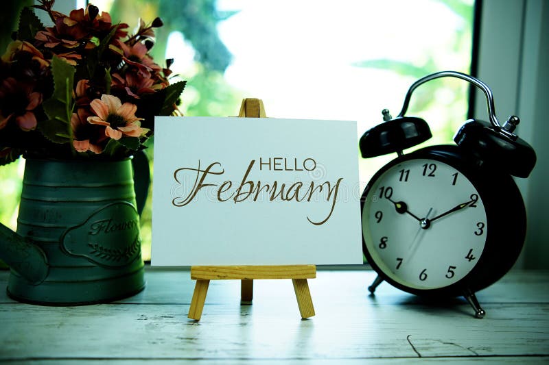 Hello February Text on Paper Card with Easel and Alarm Clock in the ...