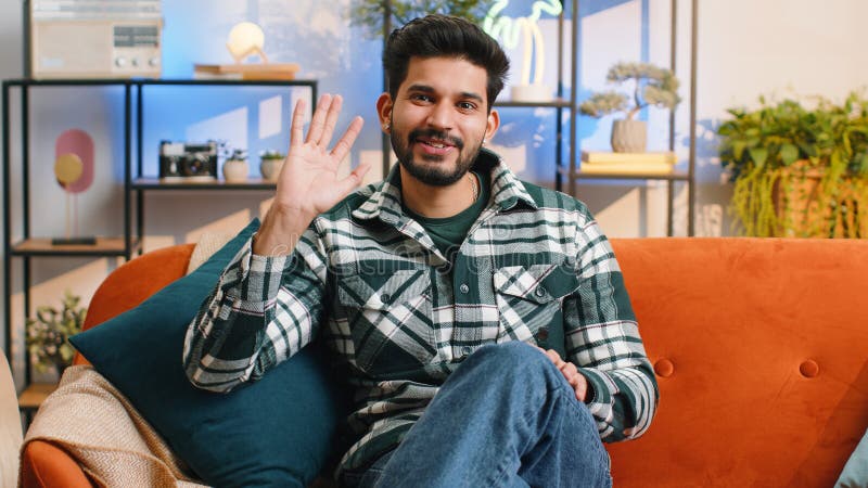 Indian Man Smiling Friendly at Camera, Waving Hands Gesturing Hello, Hi ... Indian Man Smiling Friendly at Camera, Waving Hands Gesturing Hello, Hi ...
