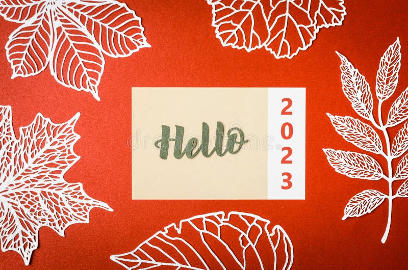 A Hello 2023 Text on Note Paper and Paper Leaves on Red Background ...