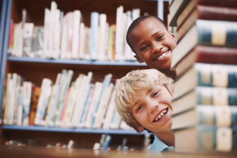 Hello. Two School Friends Peering Around a Stack of Books in the ...