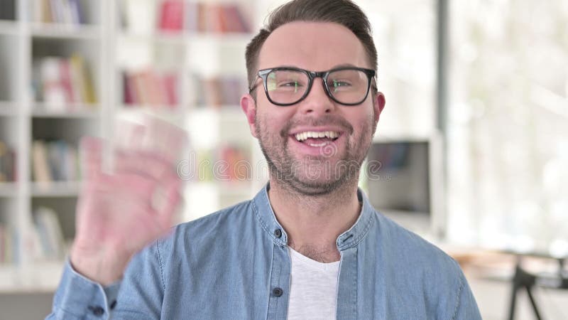 Hello, Young Man in Glasses Waving at Camera Stock Footage - Video of ...