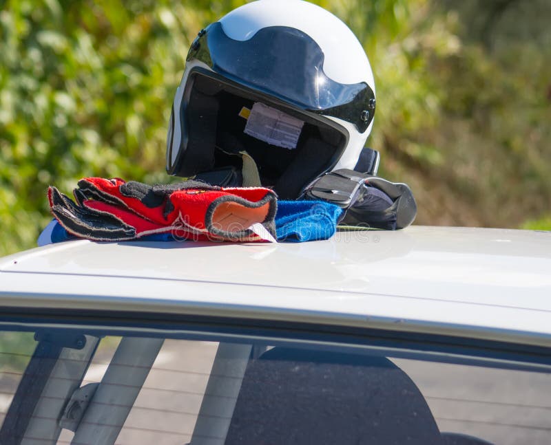 Helmet and Gloves on a Car Rooftop Stock Image - Image of drag, driver ...