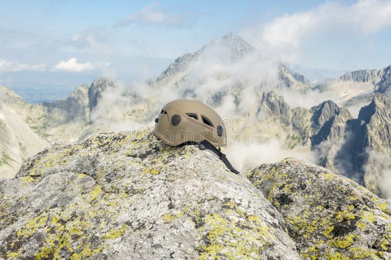Helmet in the mountains stock photo. Image of clouds - 48262026