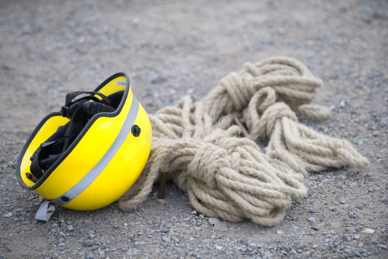 Rope, Helmet, Carabiners, Climbing Harness And Descender On A Rock In ...