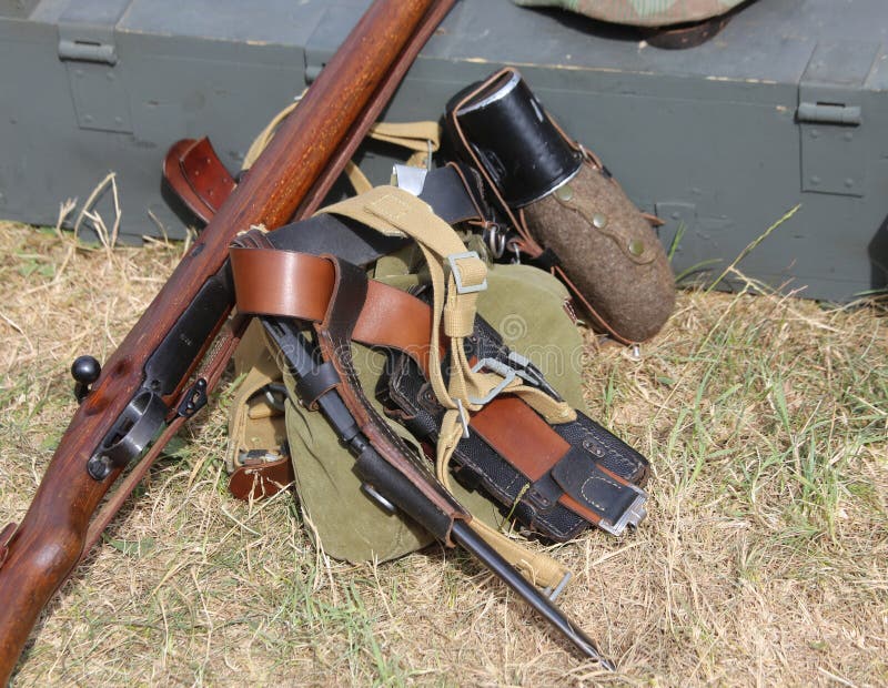 Helmet of Soldier Uniform with a Rifle in the Army Camp Stock Photo ...
