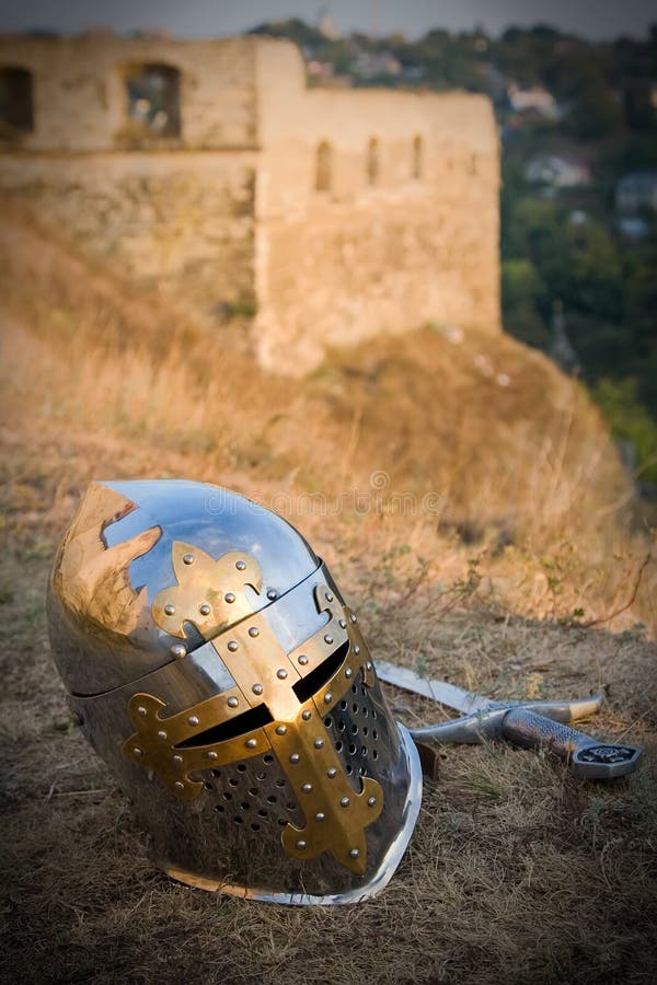 Helmet and Sword on the Grass after the Battle Stock Photo - Image of ...