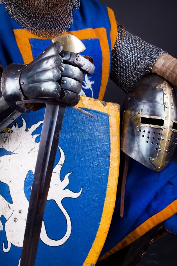 Helmet, sword in hands stock photo. Image of broken, armor - 13313916