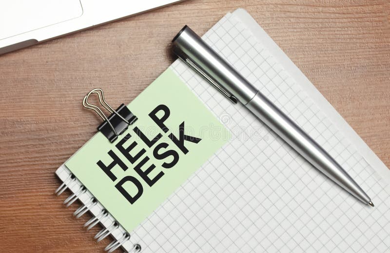 HELP DESK Sign on the Green Sticker Note and Laptop on the Brown Table ...