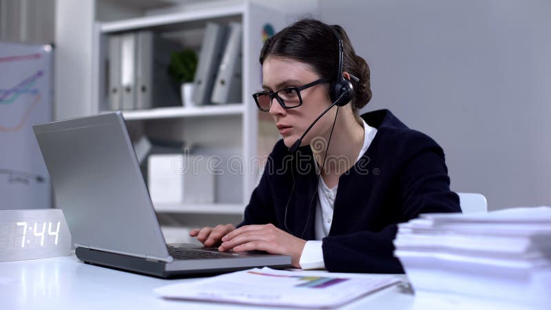 Help Desk Worker in Headset Calling Client Using Laptop, Online ...