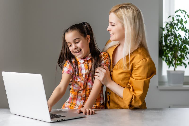 Helpful Mother Explaining To Daughter about Using a Laptop Stock Image ...