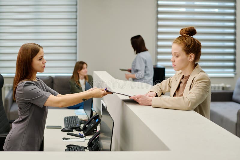 Helping Client with Medical Document Stock Photo - Image of woman ...