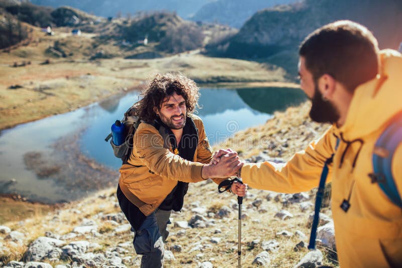 Hiker Man Getting Help on Hike Happy Overcoming Obstacle Stock Photo ...