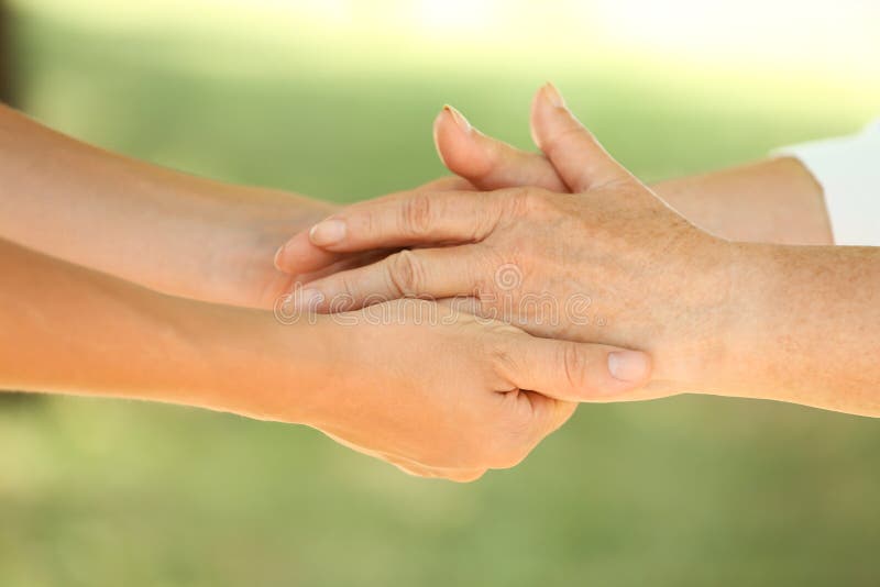Helping Hands On Blurred Background, Closeup. Stock Image - Image of ...
