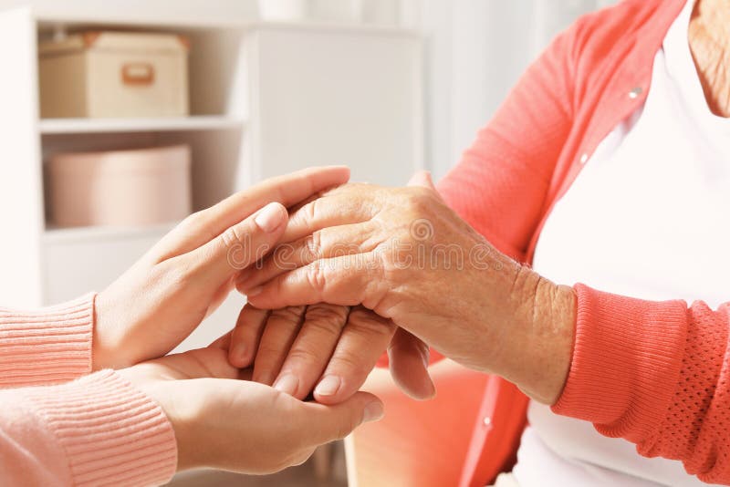 Helping Hands on Beige Background, Closeup. Elderly Care Concept Stock ...