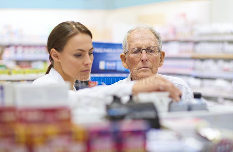 Helping Her Customer Make an Informed Choice. a Young Pharmacist ...
