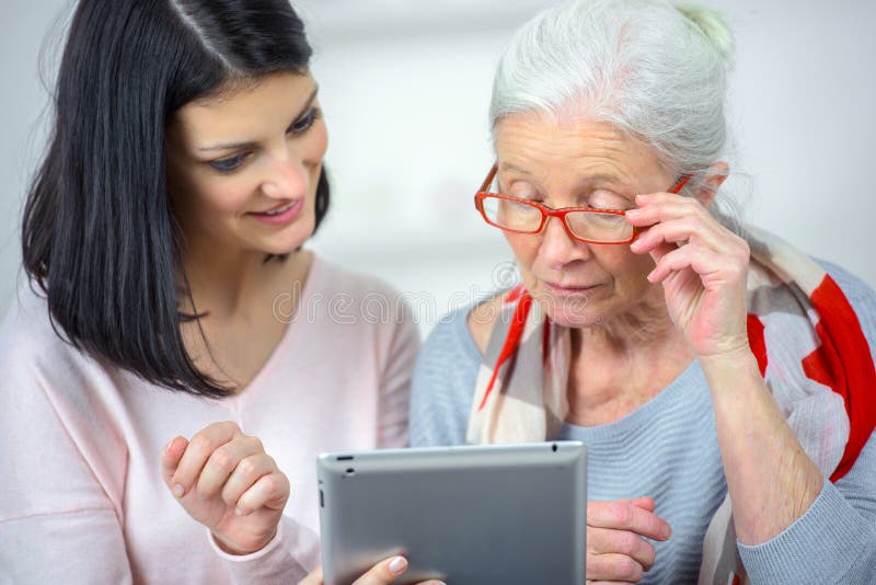 Helping Old Woman Use Tablet Computer Stock Photo - Image of dependant ...