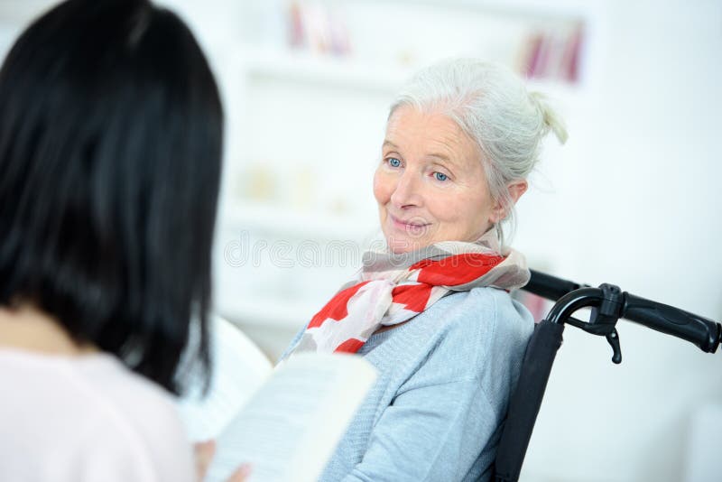 Helping Senior Woman To Read Stock Image - Image of family, sitting ...