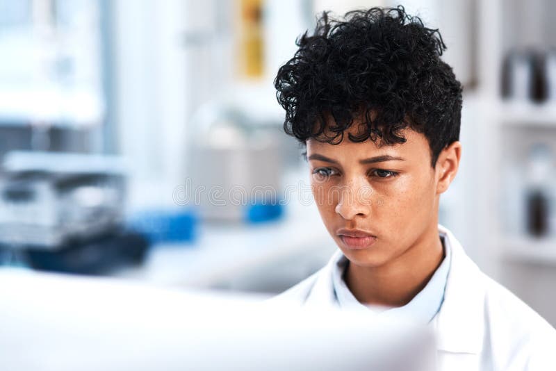 Her Focus Never Falters. a Young Scientist Working on a Computer in a ...