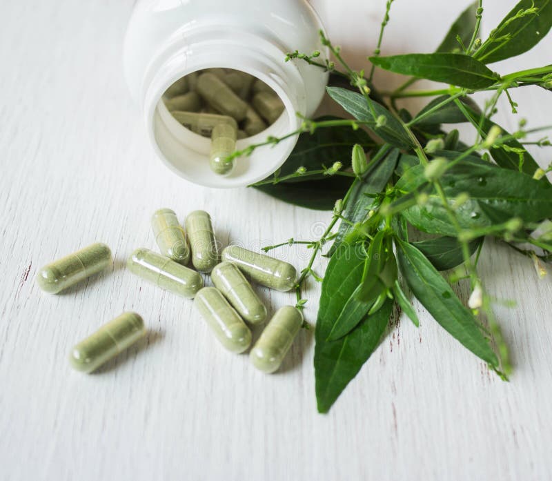 Herb capsule with bottle stock photo. Image of macro - 68471978