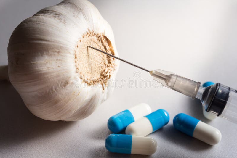 Herb for Health, Garlic with Capsules and Syringe. Stock Photo - Image ...