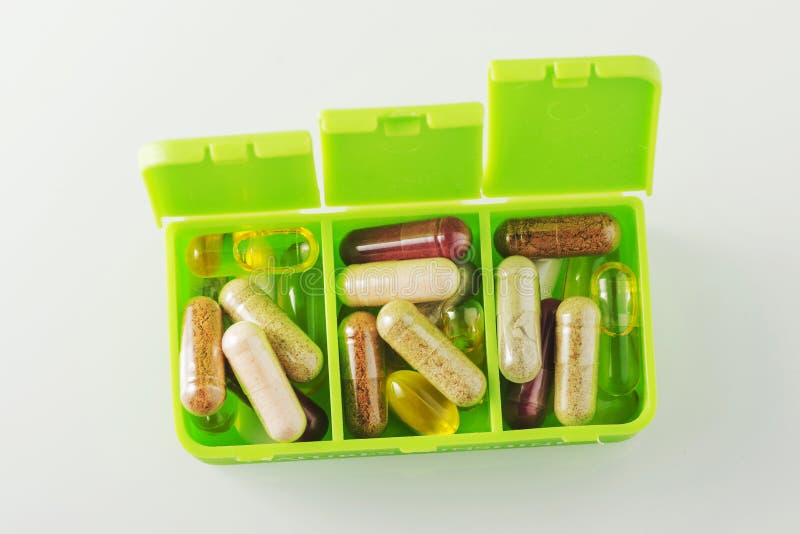 Herbal Capsules and Fish Oil Capsules in Portions Stock Image - Image ...