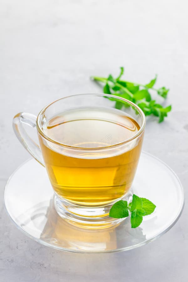 Herbal Mint Tea in a Glass Cup with Fresh Peppermint on Background ...