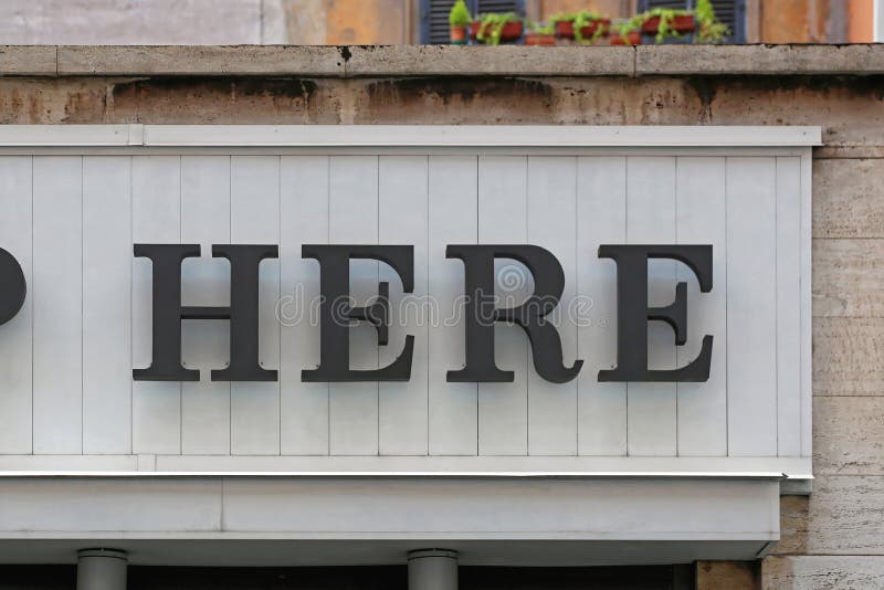 Here Text Sign stock photo. Image of simple, board, black - 103584764
