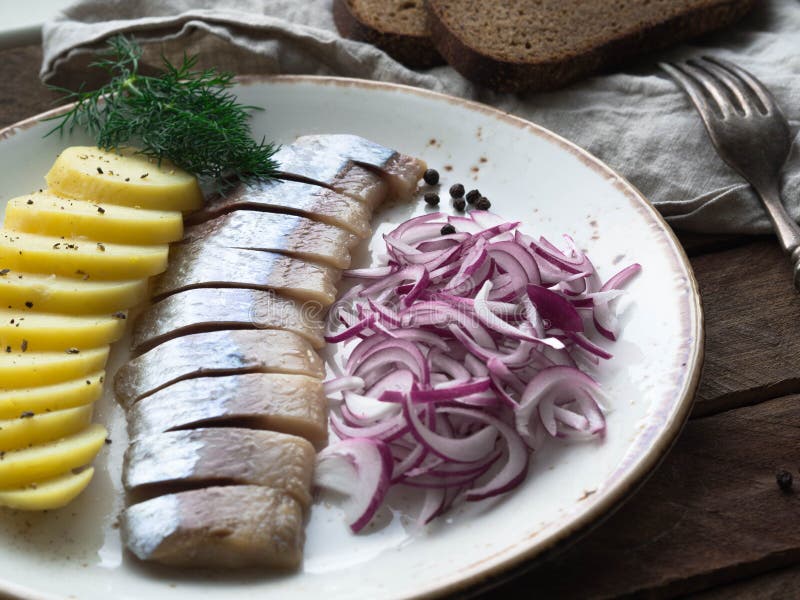 Herring Fish with Potatoes Slices and Red Onion Stock Photo - Image of ...