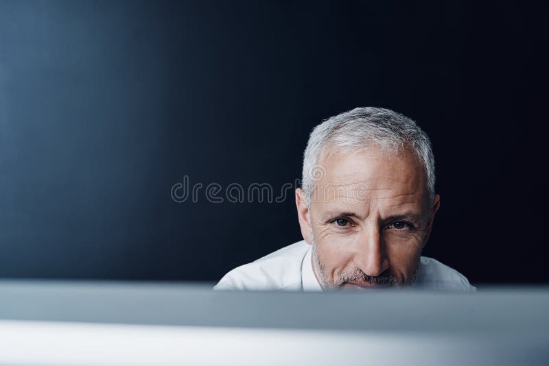 Hes always Behind His Computer Screen. a Mature Businessman Working on ...