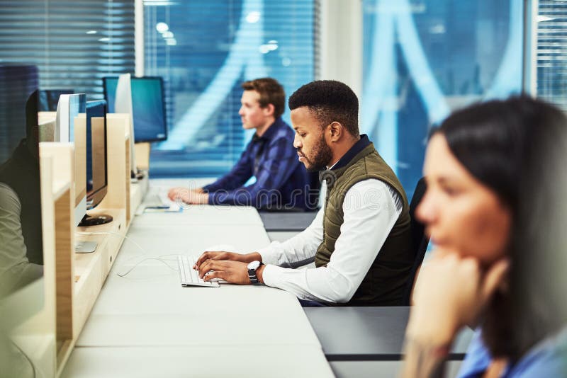 Hes a Busy Worker. a Group of Designers Working on Computers in an ...