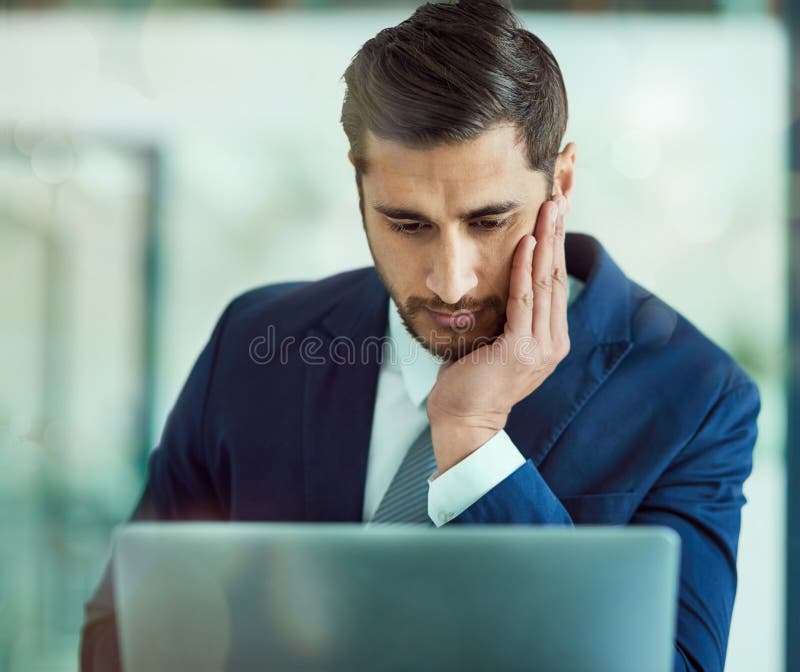 Hes a Corporate Problem Solver. a Focused Executive Working on a Laptop ...