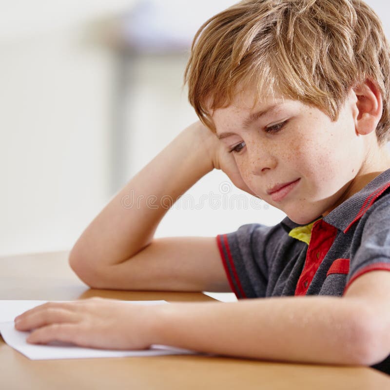 Hes a Dedicated Student. a Young Student Reading through His Work at ...