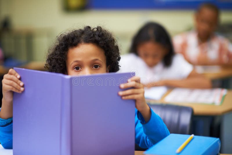 Hes a Diligent Student. Portrait of a Young Schoolboy Reading from a ...
