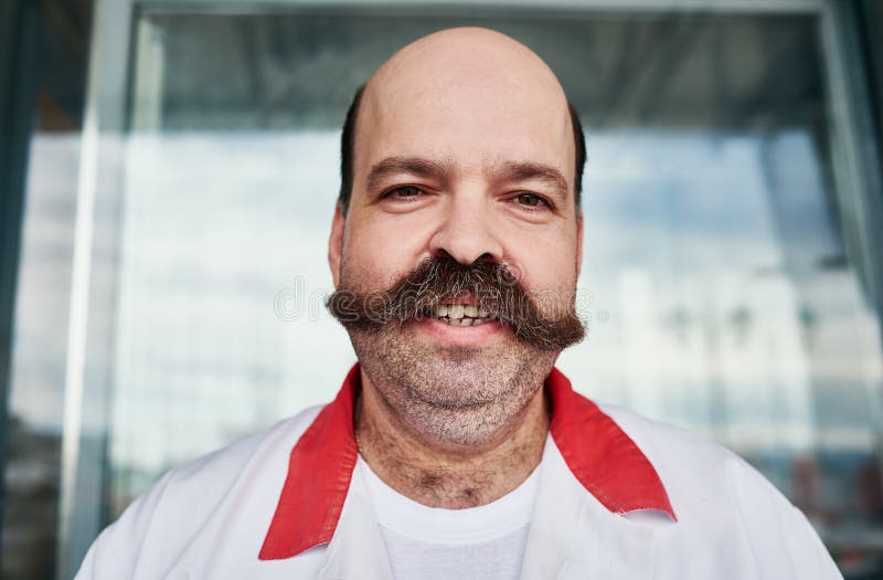 Hes a Friendly Butcher. Shot of a Butcher at His Store. Stock Photo ...