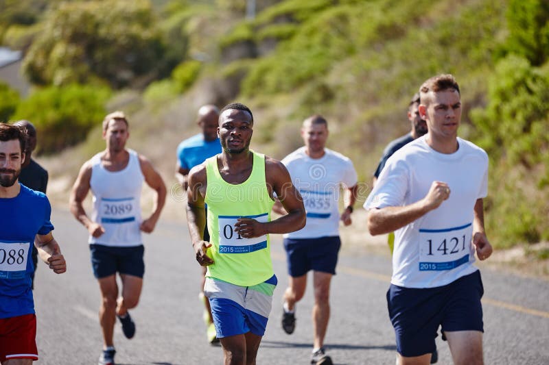Hes Giving it His All in this Marathon. a Group of Young Men Running a ...