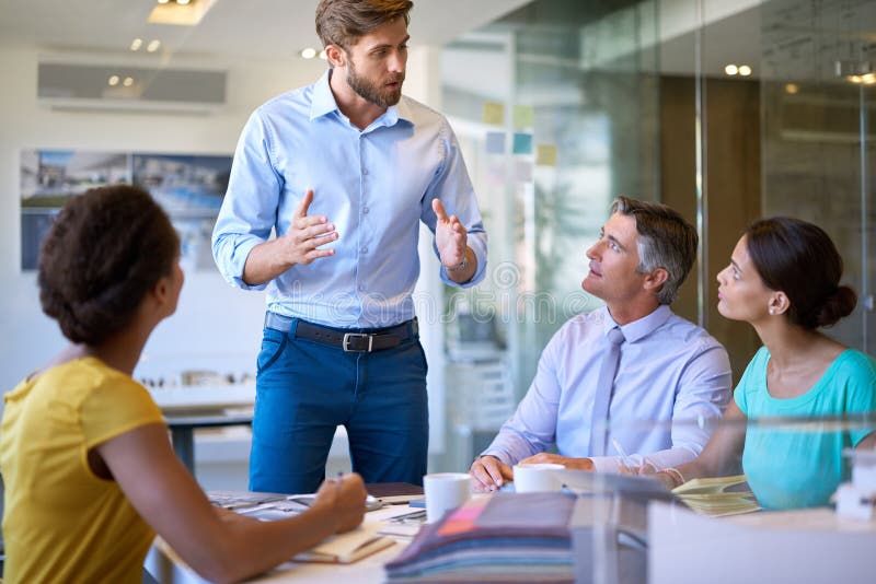 Hes Got Their Attention. a Group of Businesspeople in a Meeting. Stock ...