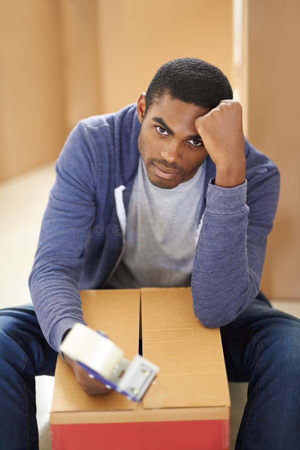 Hes Moving House. a Handsome Young Man Packing Boxes. Stock Photo ...