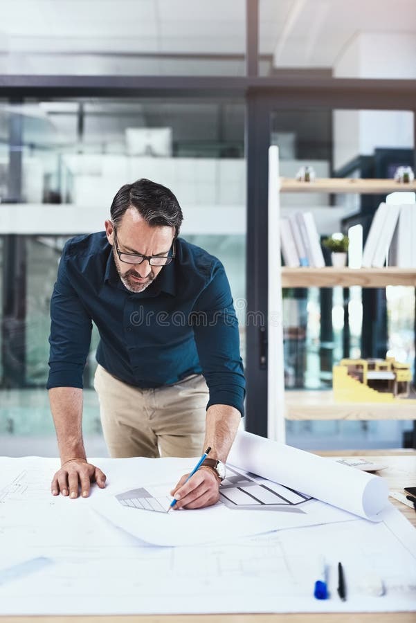 Hes a Problem Solver. a Mature Male Architect Working on a Design in ...