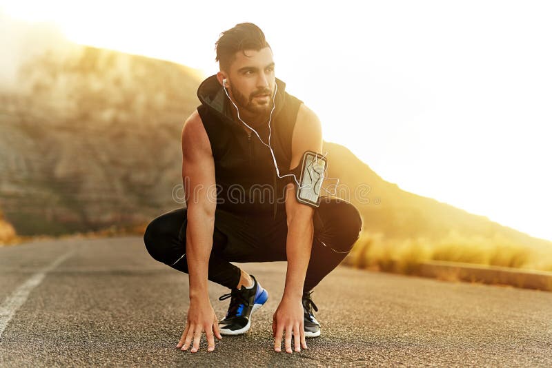 Hes Ready To Run. Shot of a Young Man Exercising Outdoors. Stock Photo ...