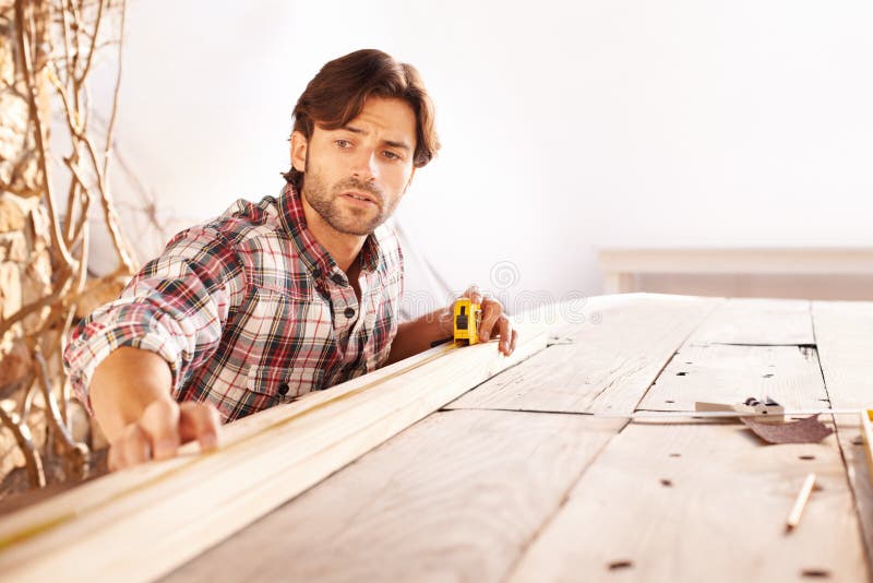 Hes a Skilled Carpenter. a Handsome Young Carpenter Measuring and ...