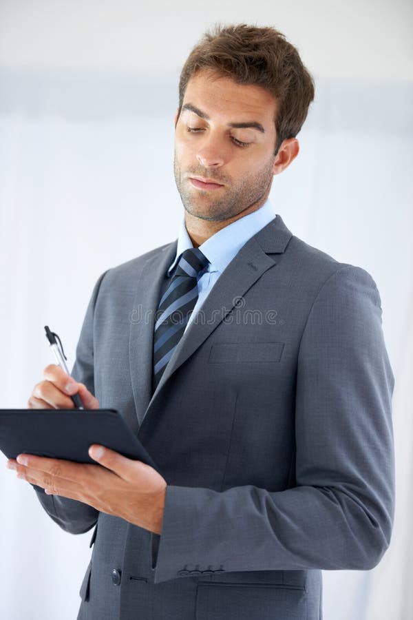 Hes always Taking Note. a Handsome Businessman Standing with a Suit and ...