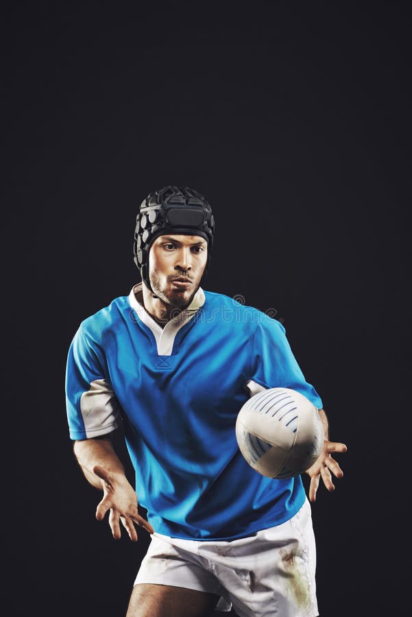 Hes a True Athlete. Studio Shot of a Young Rugby Player Catching a Pass ...