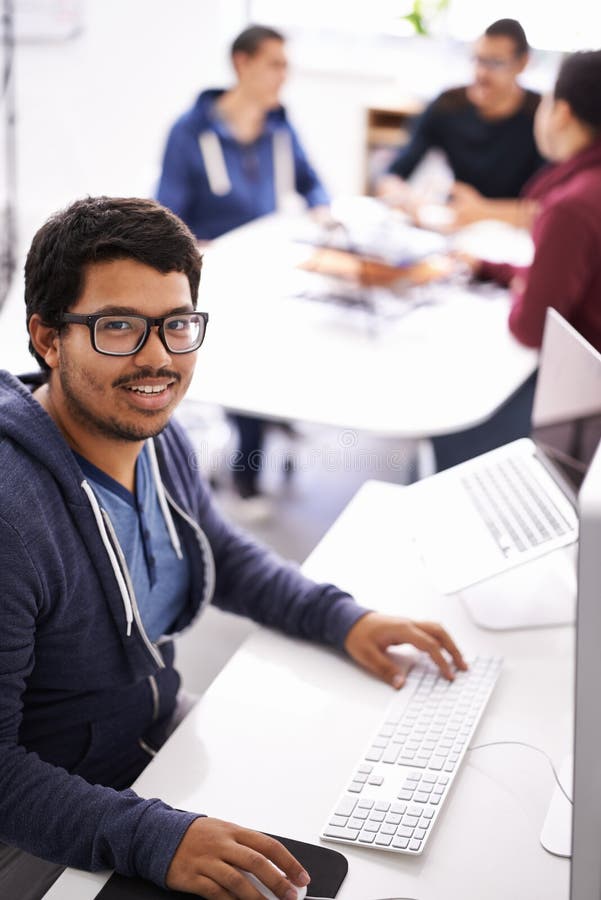 Hes a Valuable Member of the Team. a Young Man Working on His Laptop in ...