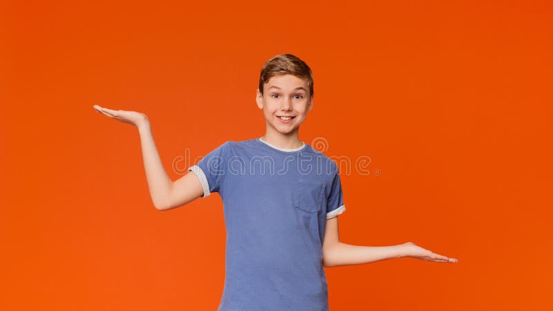 Hesitant Boy Spreading Hands Sideway with Empty Space Stock Photo ...