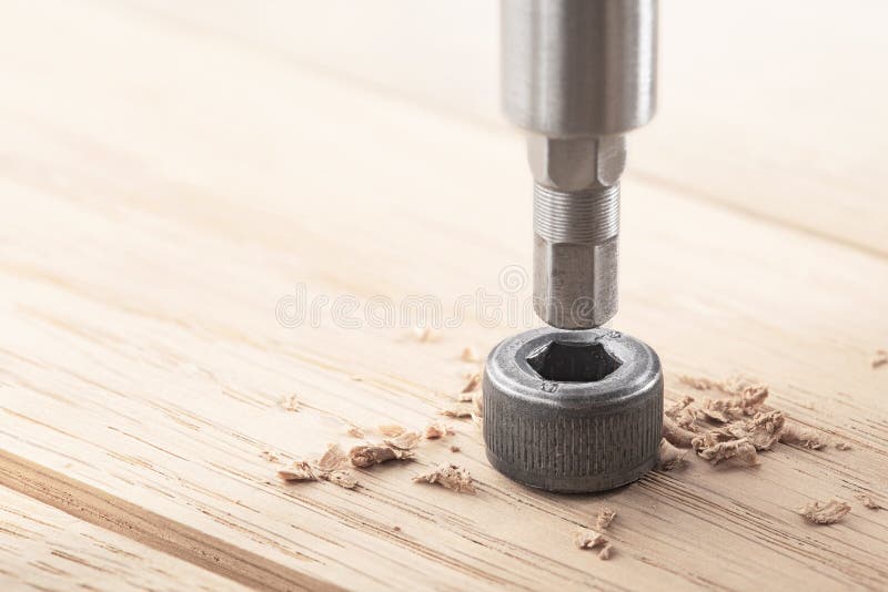 Hex Bolt Hex Bit in Wooden Oaks Plate. Spanner, Bolt, and Nuts Stock ...